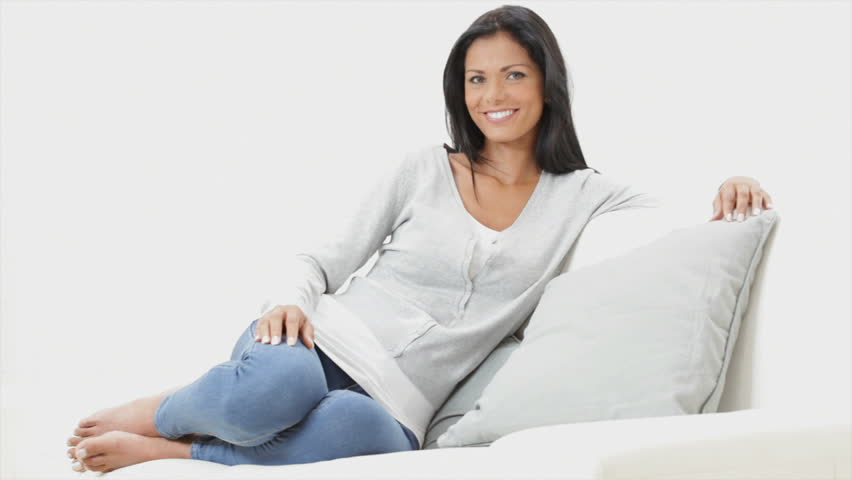 Beautiful Young Woman Sitting On The Sofa At Home Relaxed Woman With