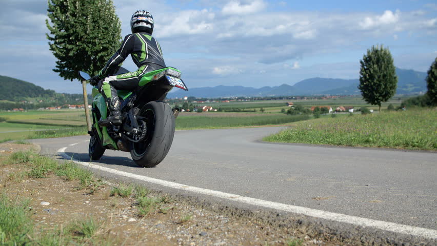 A Biker Riding A Customized Motorcycle On An Open Road Stock Footage ...