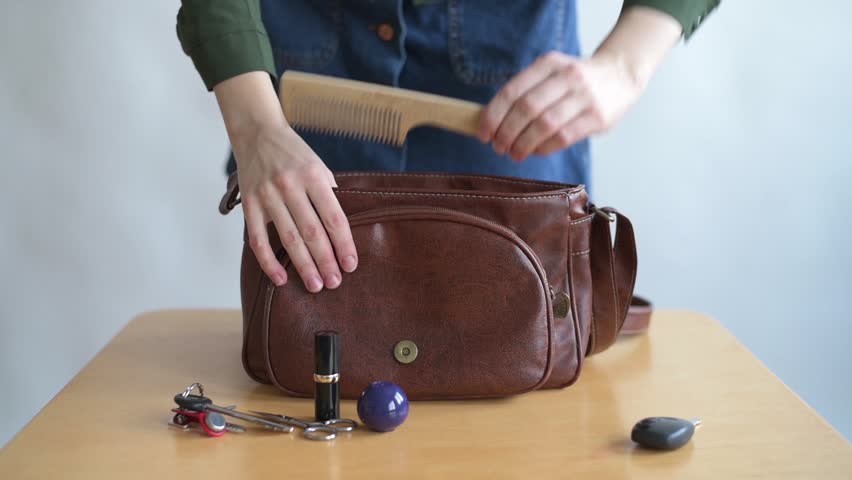 Young Girl Is Putting Her Stuff In A Handbag. Then She Takes A Bag And ...