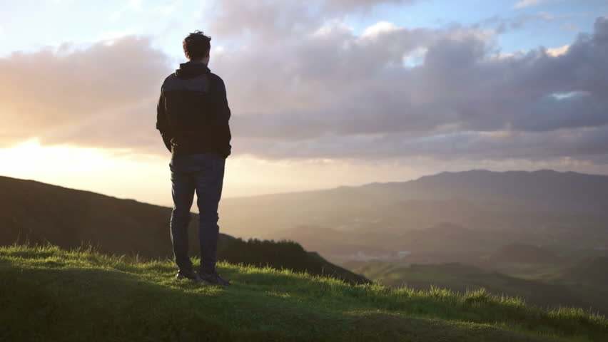 Young Caucasian Man Looking Down From The Mountaine Towards The Ocean ...