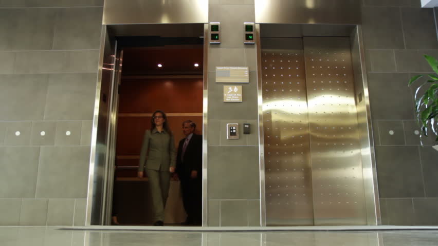 Business People Get Out Of An Elevator And Leave Frame. Wide View ...