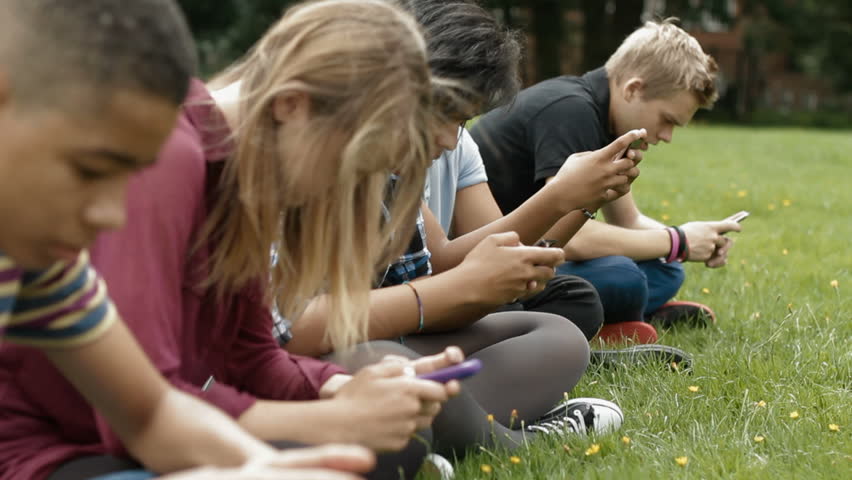 Teens On Cell Phones - Teenagers All Texting Or Playing Games On Their ...