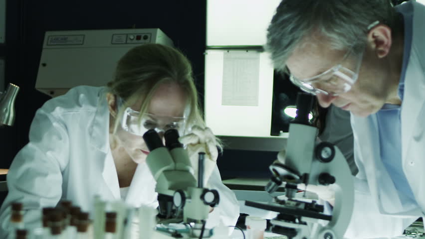 Diverse Team Of Scientists Or Researchers Working Together In A Dark ...