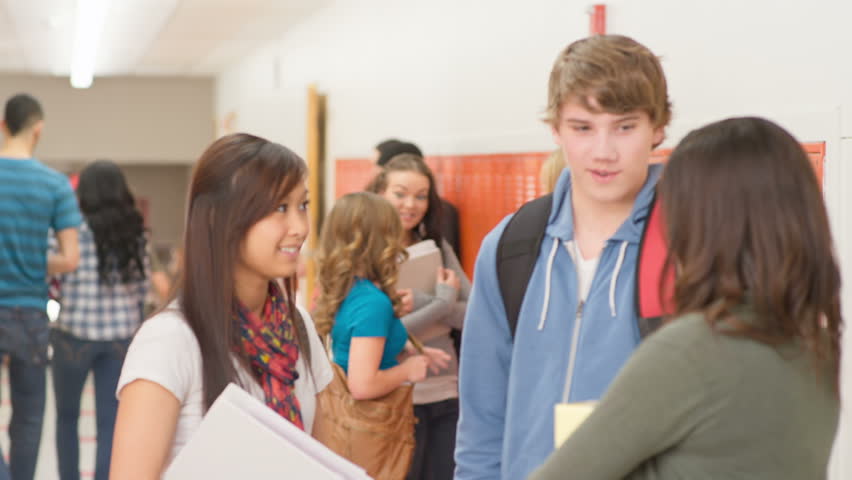 Diverse Group Of University Or College Students Chat Together As They ...