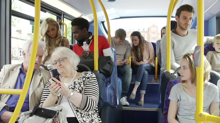 Interior Of Crowded Bus With Passengers Listening To Music And Using ...