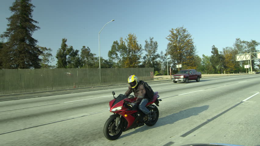 Man Riding His Motorcycle On A Highway Follow Shot Car Point Of View ...