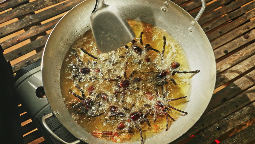 Deep Fried Tarantulas In Wok Cooking Using A Metal Spatula , Southeast ...